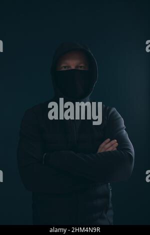 Scary man hiding in the shadows, with the face and identity hidden with ...