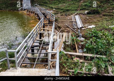 Construction of pedestrian bridge along the reservoir. The structure of ...