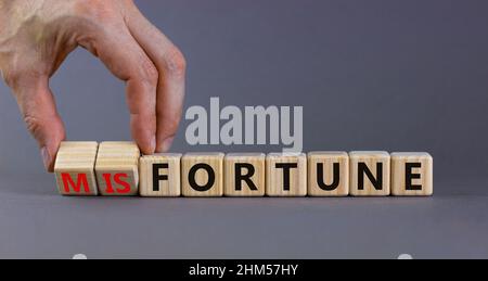 Fortune or misfortune symbol. Businessman turns wooden cubes and ...