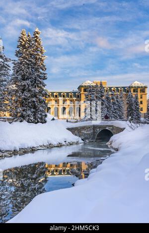 A view of a partially frozen Lake Louise in winter, Banff National Park ...