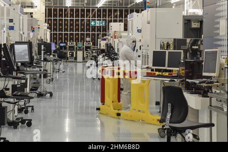 07 February 2022, Belgium, Löwen: An employee sits in a research center ...