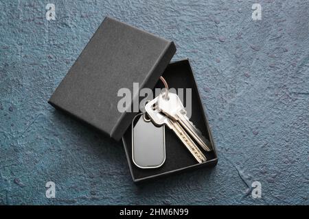 Keys with stylish keychain on dark background Stock Photo - Alamy