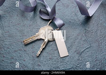 Keys with stylish keychain on dark background Stock Photo - Alamy