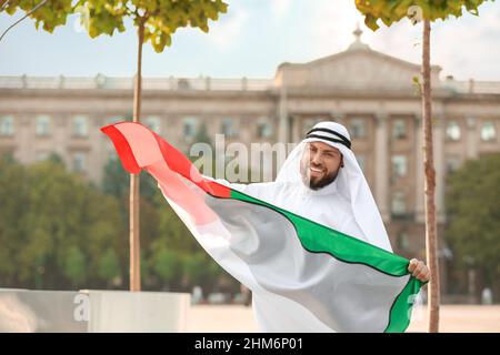 Smiling Muslim man with UAE flag outdoors Stock Photo - Alamy
