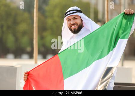 Smiling Muslim man with UAE flag outdoors Stock Photo - Alamy