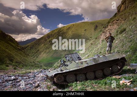 Soldier near the damaged armored personnel carrier Stock Photo - Alamy