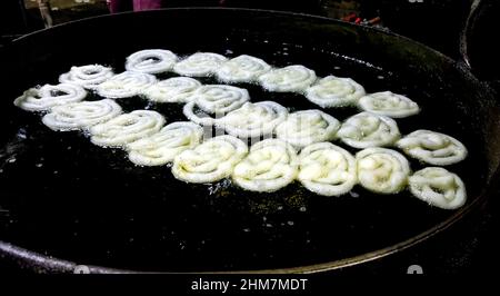 Jalebi is a famous indian sweet. frying sweets jalebi in oil, indian ...
