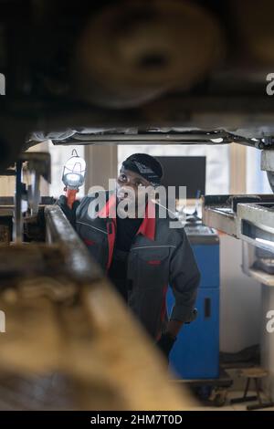 mechanic inspecting a vehicle part Stock Photo - Alamy