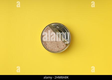 Tin can with delicious pate and slices of bread on wooden table, flat ...