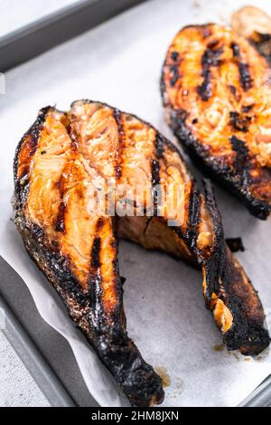 Grilled salmon steaks on a baking sheet with parchment paper Stock ...