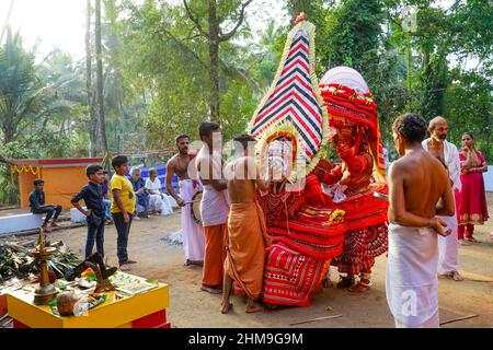 Traditional Theyyam performer adorned in elaborate costume and makeup ...