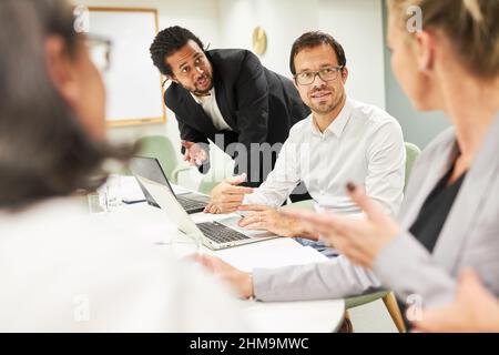 Business team discussing strategy at computers during office analytics ...