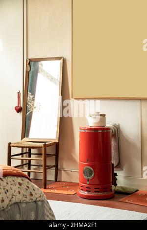 Interior of room with old fashioned potbelly stove with kettle placed ...
