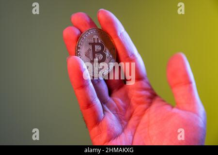 Bitcoin gold coin on neon color background. Virtual cryptocurrency ...
