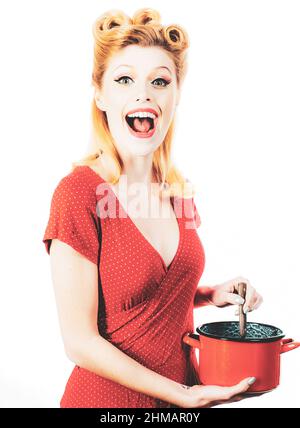 Funny woman winking in the kitchen and cooking Stock Photo - Alamy