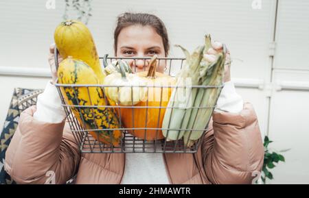 Woman with basket of autumn vegetables. Harvest in garden, farm. Ripe ...