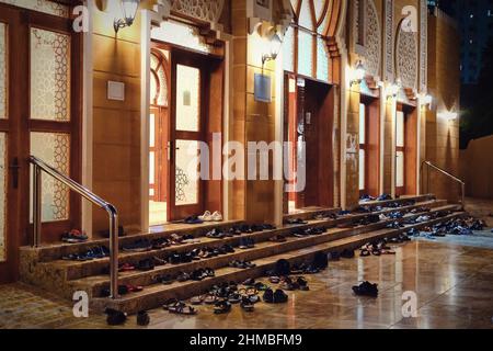 Muslims people take off shoes on steps of mosque entrance before friday ...