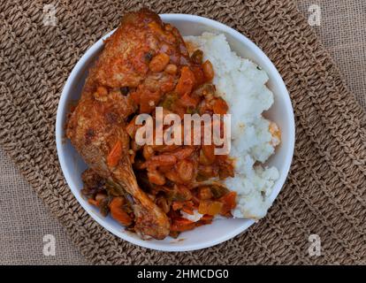 Traditional south African pap and roasted chicken, maize meal with ...