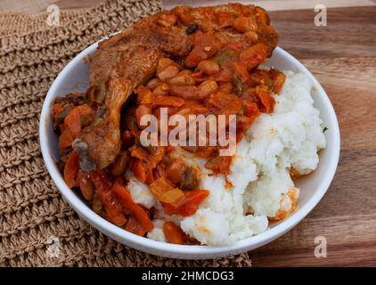 Traditional south African pap and roasted chicken, maize meal with ...