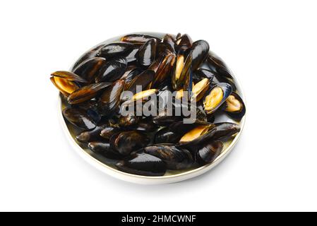 steamed mussels entree. Cooked mussels on white plate on white ...