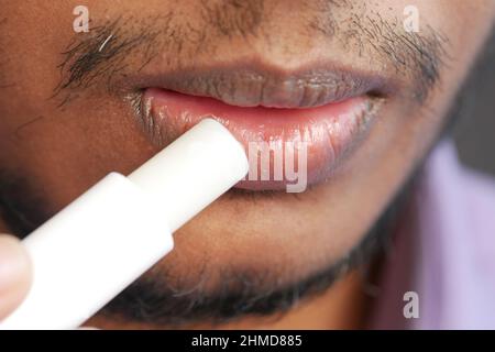 Man applying lip balm Stock Photo - Alamy