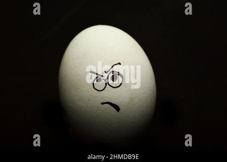 Egg represent energy human face isolated against black background Stock ...