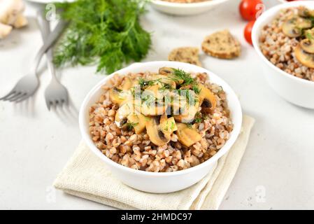 Buckwheat porridge with roasted mushrooms in white bowl Stock Photo - Alamy