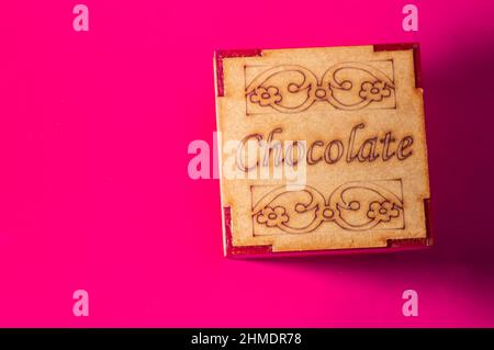 chocolate box written with pink background copy space and selective ...