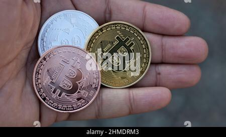 Bitcoin gold, silver and copper coins and defocused printed circuit ...