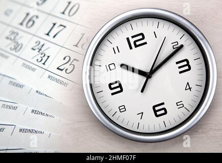large white clock face with calendar sheets closeup Stock Photo - Alamy
