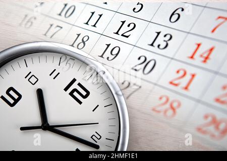 large white clock face with calendar sheets closeup Stock Photo - Alamy