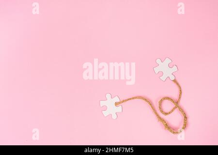 the connection with a string between two pieces of puzzle on a ...