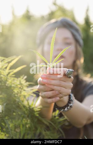 Woman in the Cannabis plant, Girl standing with Marijuana or Hem Stock ...