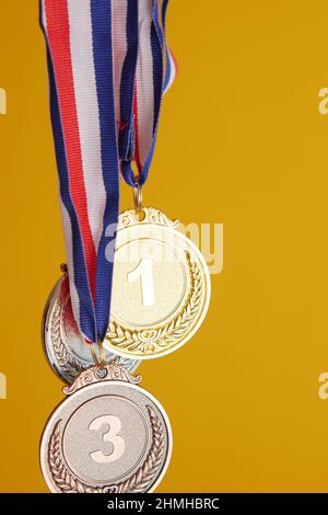 First Place Throphy against yellow background Stock Photo - Alamy