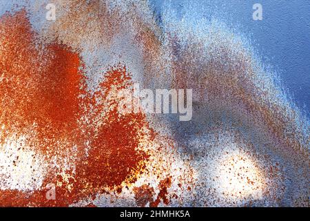 blue and orange painted metal, scratched and worn, textured and ...