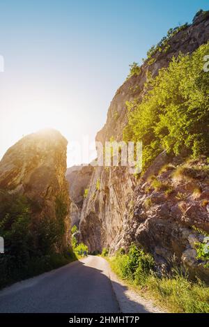 Narrow road pass between rocky cliffs Stock Photo - Alamy