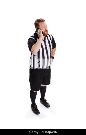 Full length portrait of a football referee with a smartphone with ...
