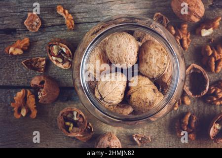 Whole solid walnuts in a jar top view Stock Photo - Alamy
