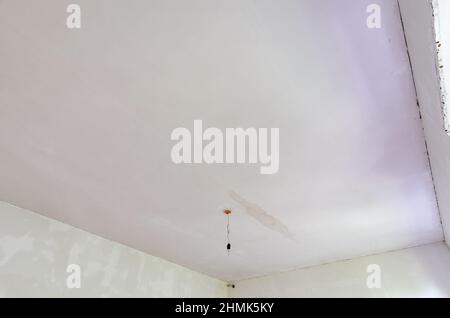 Plastered ceiling in the room, stains from flooding from above are ...