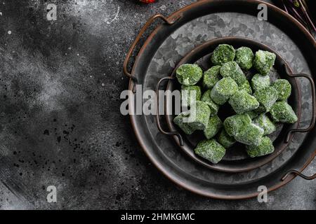 Frozen spinach blocks set, on old dark wooden table background, top ...