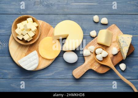 Different cheese on color wooden background Stock Photo - Alamy