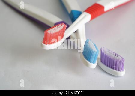 three color of toothbrush, red, blue, and purple Stock Photo - Alamy