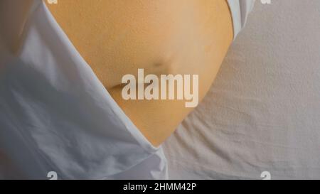 Fracture of the coccyx of the spine. External medical exam by a doctor ...