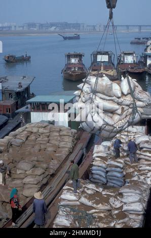 Worker offload Sand for Construction off a Transport ship at the ...