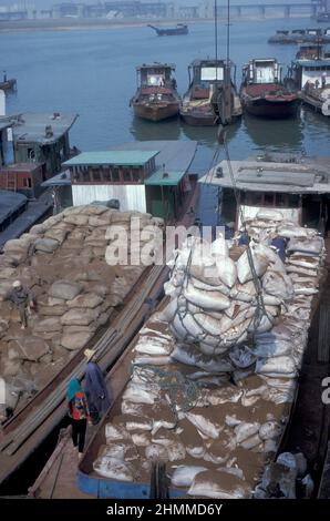 Worker offload Sand for Construction off a Transport ship at the ...