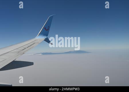 A wing of a Boeing 737 TUI chartered airplane taken in flight showing ...