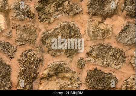 The photo shows a stone wall; the delimitation of the natural stone of ...