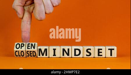 Open or closed mindset symbol. Businessman turns wooden cubes and ...