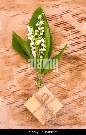 Beautiful lily-of-the-valley flowers and greeting card on white ...