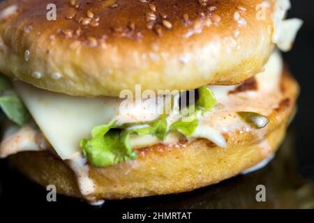 Burger with appetizing crust on a dark background Stock Photo - Alamy